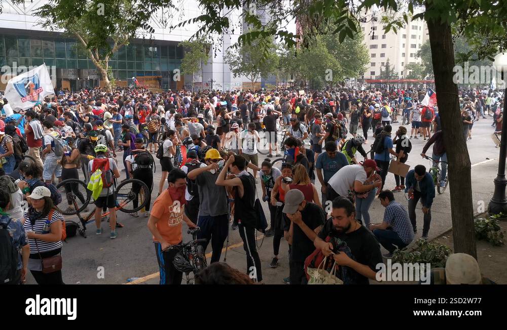 Real people crowd protesting and repealed with tear gas at Santiago de ...