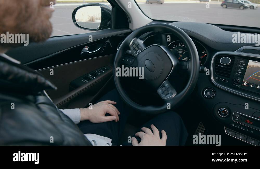 Self-driving autonomous car is parking by itself. The wheel is ...