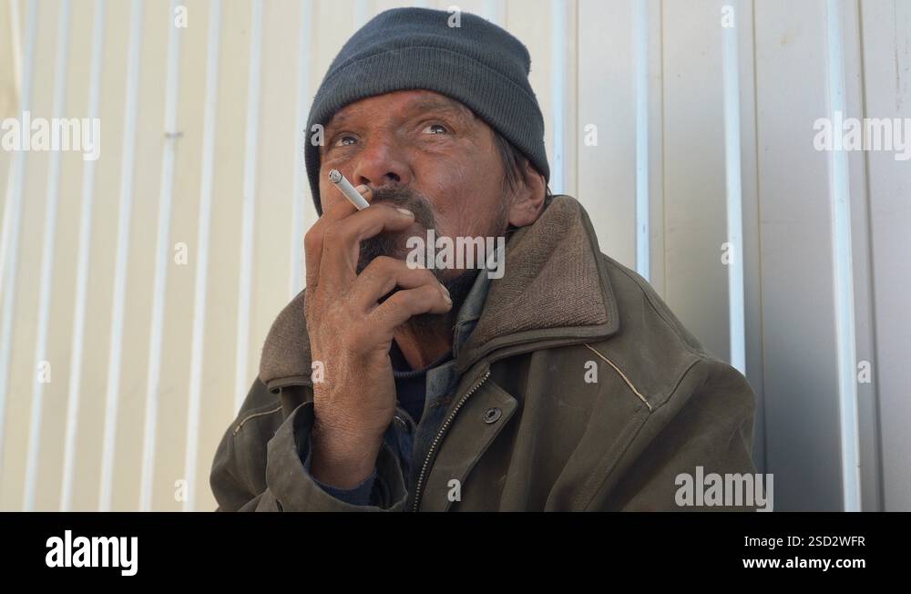 Homeless man with tears in his eyes smoking cigarette Stock Video ...