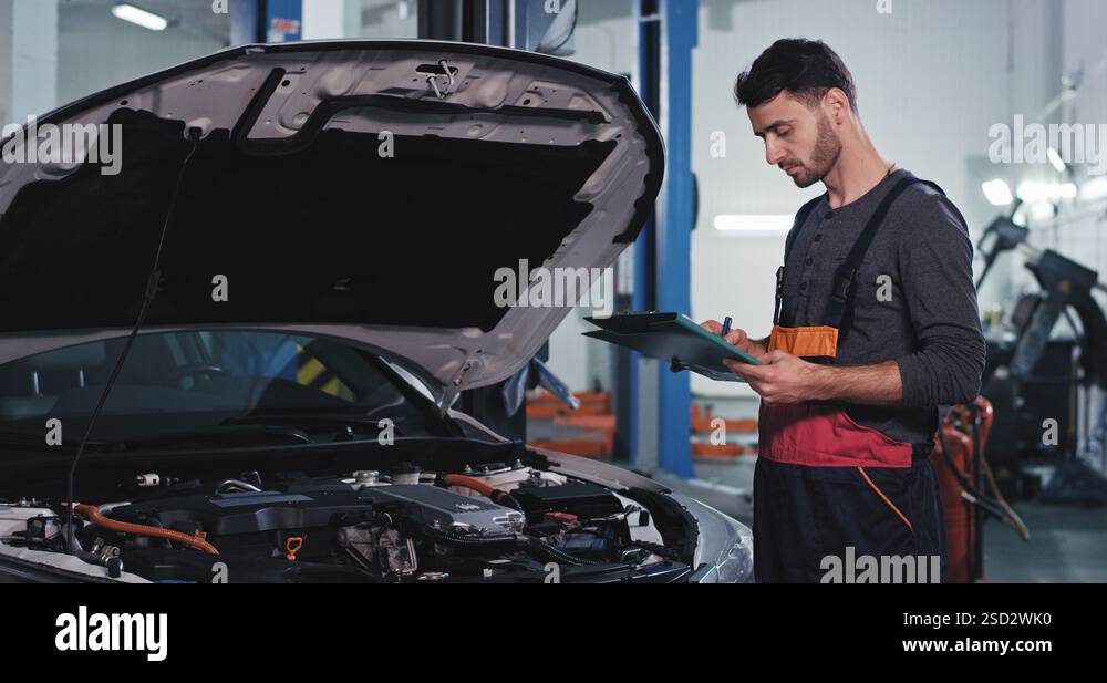 Concentrated mechanic man in a uniform check from the map list what ...