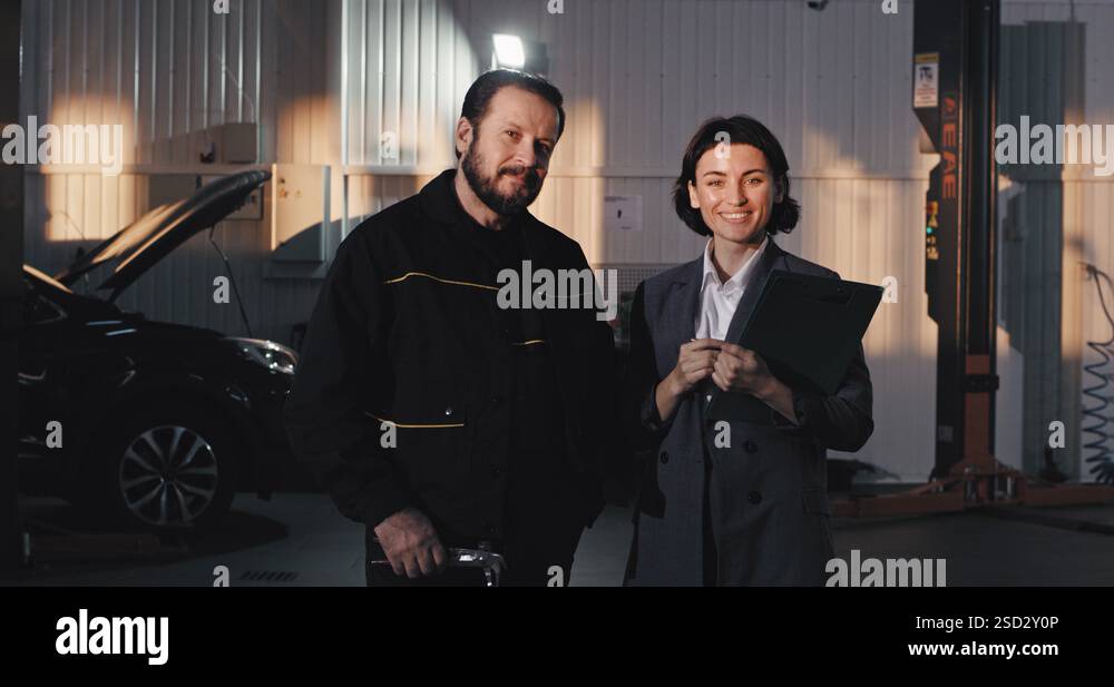 Attractive workers from a modern auto service main mechanic man and the ...