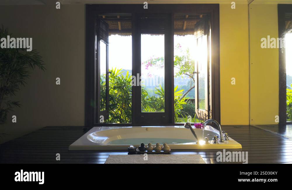 Luxury whirlpool jacuzzi with hot water and flowers and window ...
