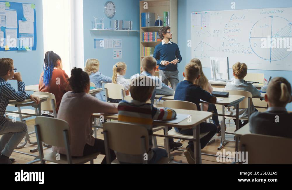 Caring Teacher Explains Lesson to a Classroom Full of Bright Diverse ...
