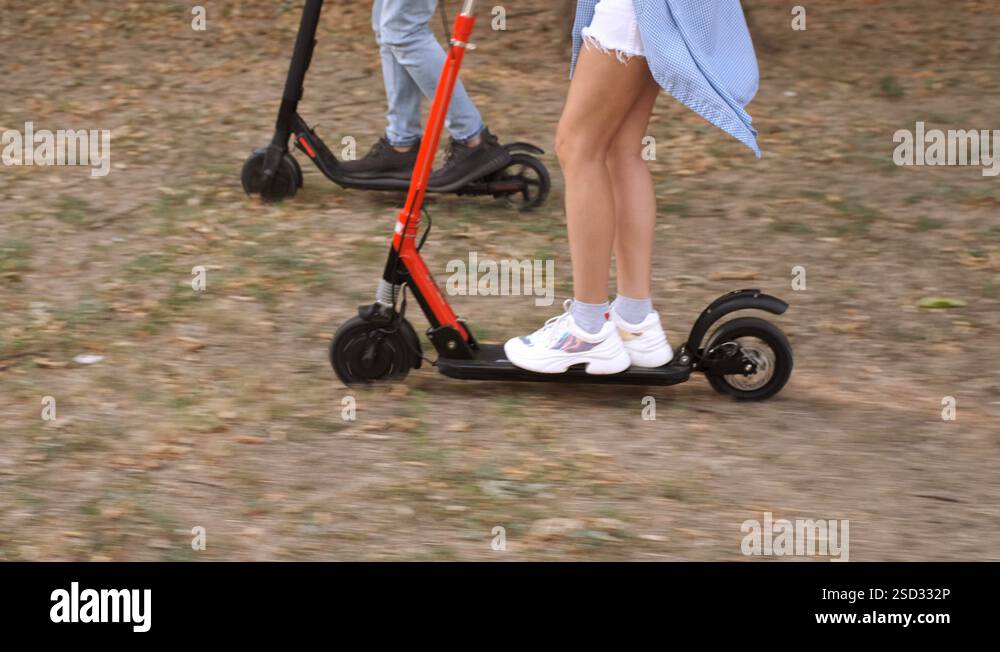 cute couple rides electric scooters on grass side view Stock Video ...
