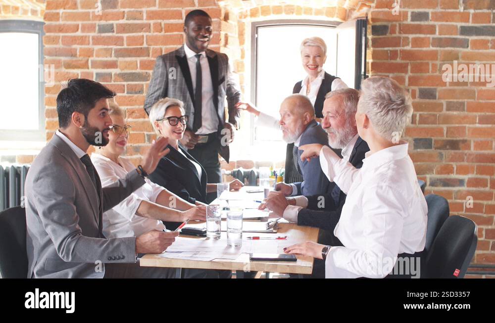 Happy multiracial employees involved in teamwork in workplace with ...