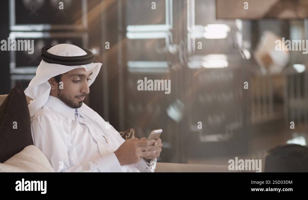 Qatari man messaging on mobile Stock Video Footage - Alamy