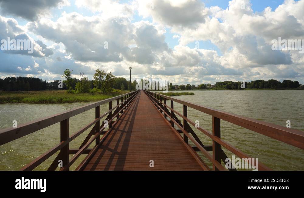 Walking on longest pedestrian bridge connecting two lake shores Stock ...