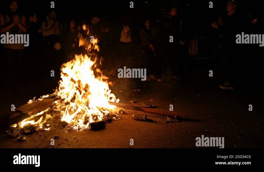 Fire and barricades at night time during the riots at Santiago de Chile ...
