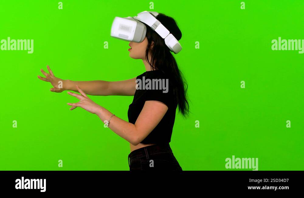 Interaction on a VR game by a teenage girl over green screen Stock ...