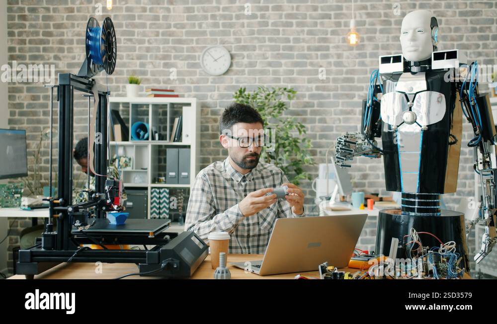 Young developer giving 3d printed model to smart robot testing machine ...