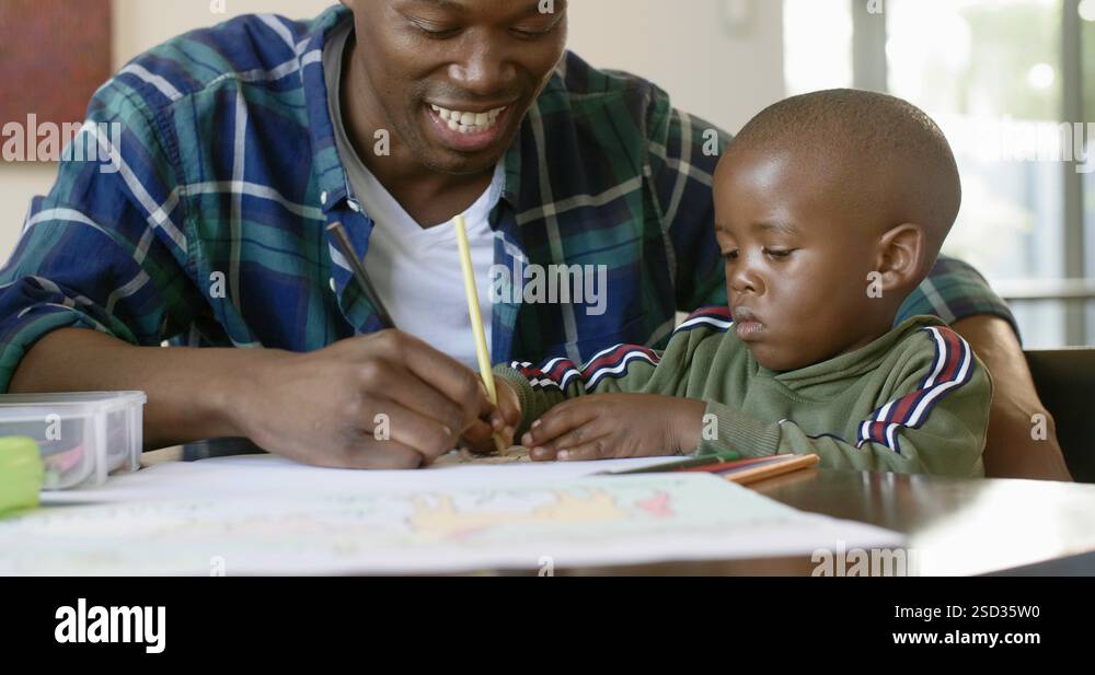involved dad colouring with kid Stock Video Footage - Alamy