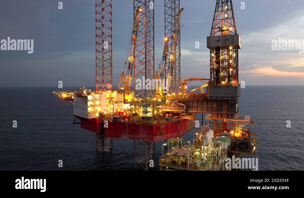 Offshore jack-up drilling rig during sunset Stock Video Footage - Alamy