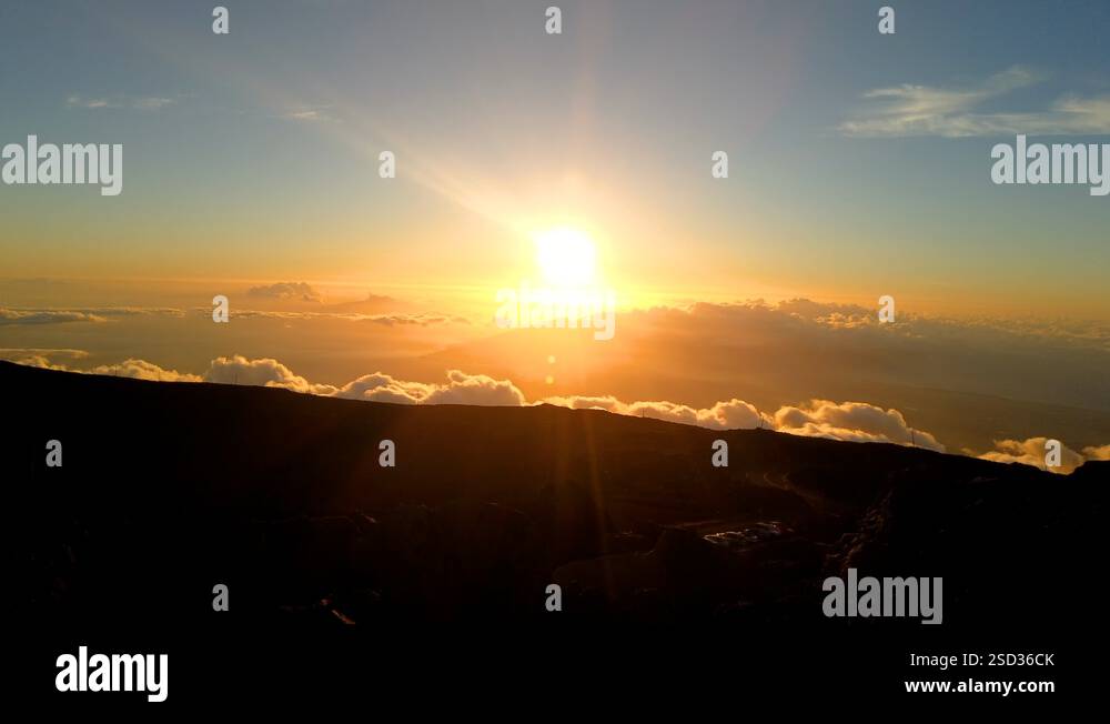 Time Elapse of setting sun above moving clouds at top of Haleakala ...