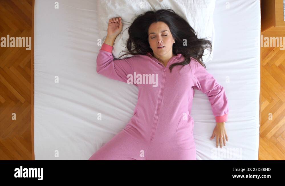 Portrait from above of cute plus size model sleeping during the morning ...