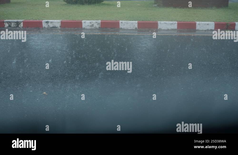 Heavy raining on the road from vehicle window scene with passing car ...