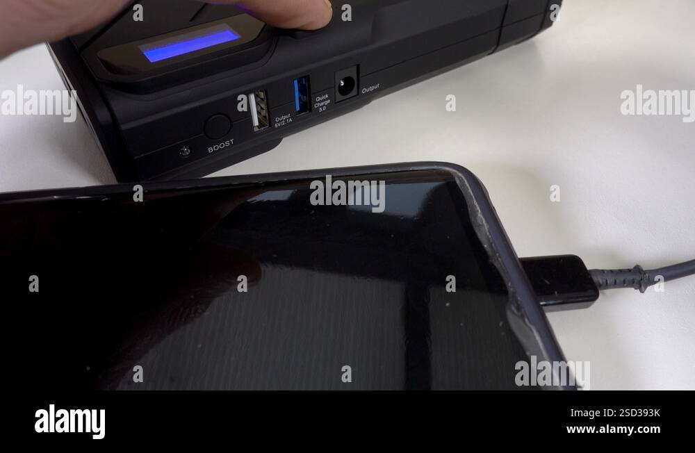 Connecting a portable battery charger to a mobile phone Stock Video ...