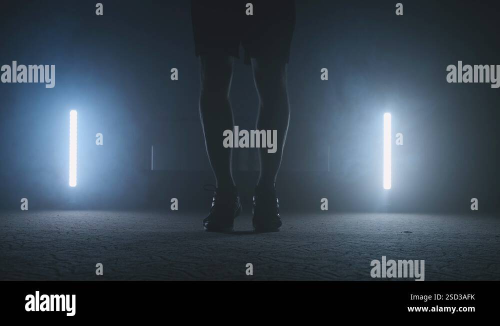Legs of male boxer with skipping rope. Fighter doing jump rope ...