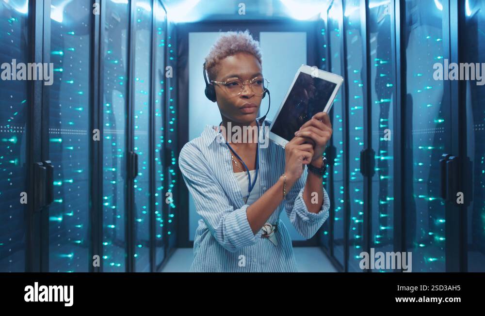 Dangerous african female secret agent holding tablet like pointing a ...