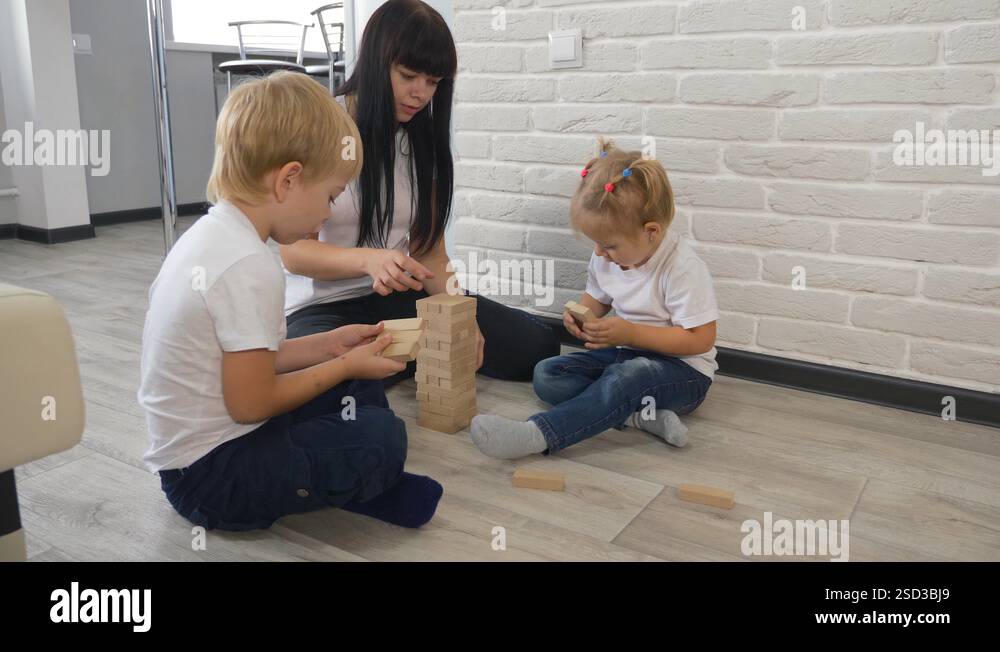 Happy family. A woman and children play a game. Mother and children ...