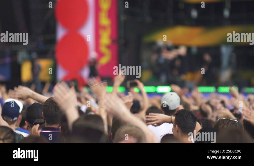 Night rock concert front row crowd cheering hands in air. Series of ...