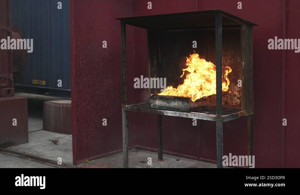 Dazzling yellow and red flame with dancing forks over a black tub in ...