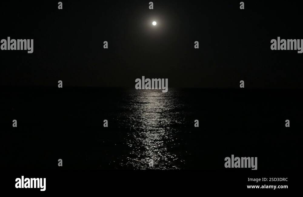The full moon illuminates the water surface. Moon track on the surface ...