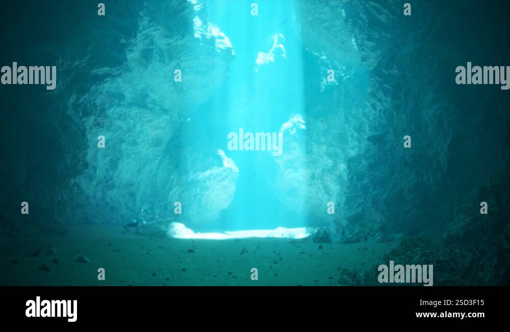 Underwater cave illuminated by sunbeams pouring through a surface ...