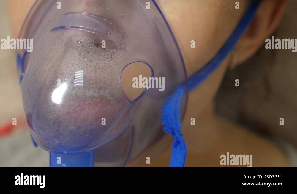 Cough treatment. Close-up. A sick woman in a mask is inhaled. a girl in ...