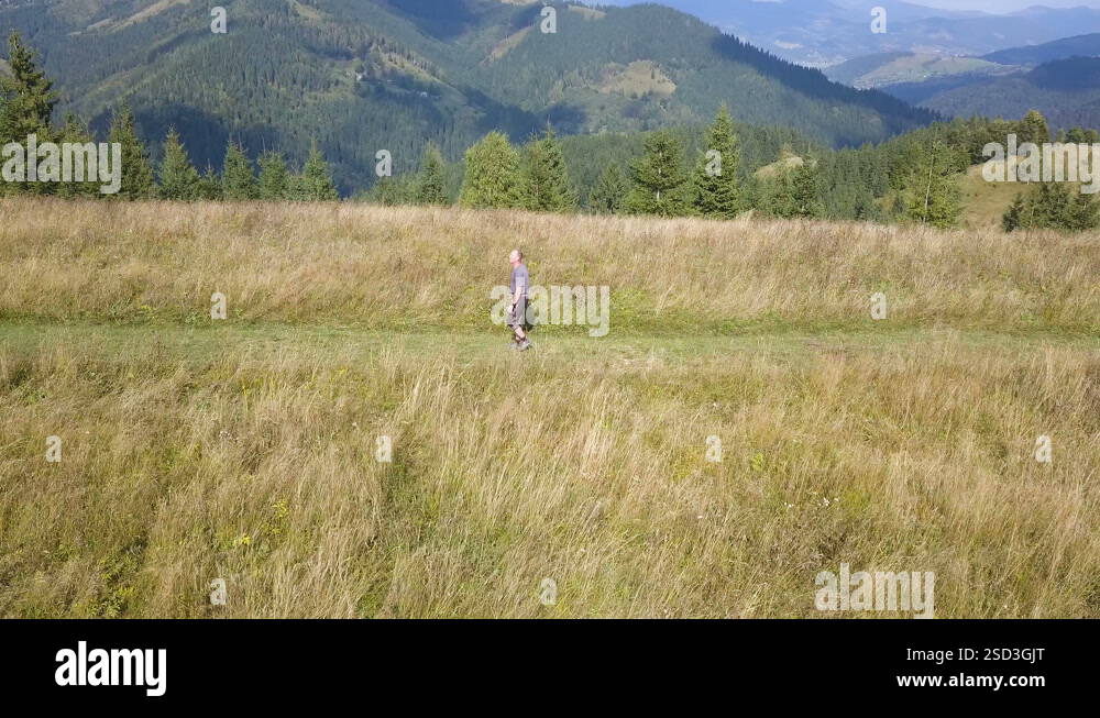 4K .Aerial. Man tourist go on ridge in mountain area Stock Video ...