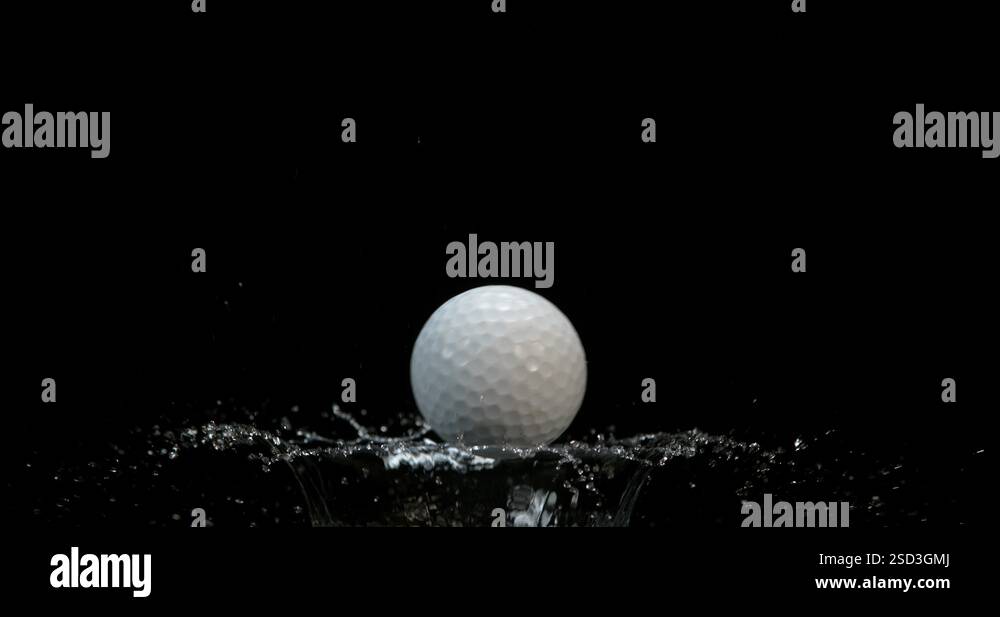 Golf's Ball Falling into Water against Black background, slow motion 4K ...