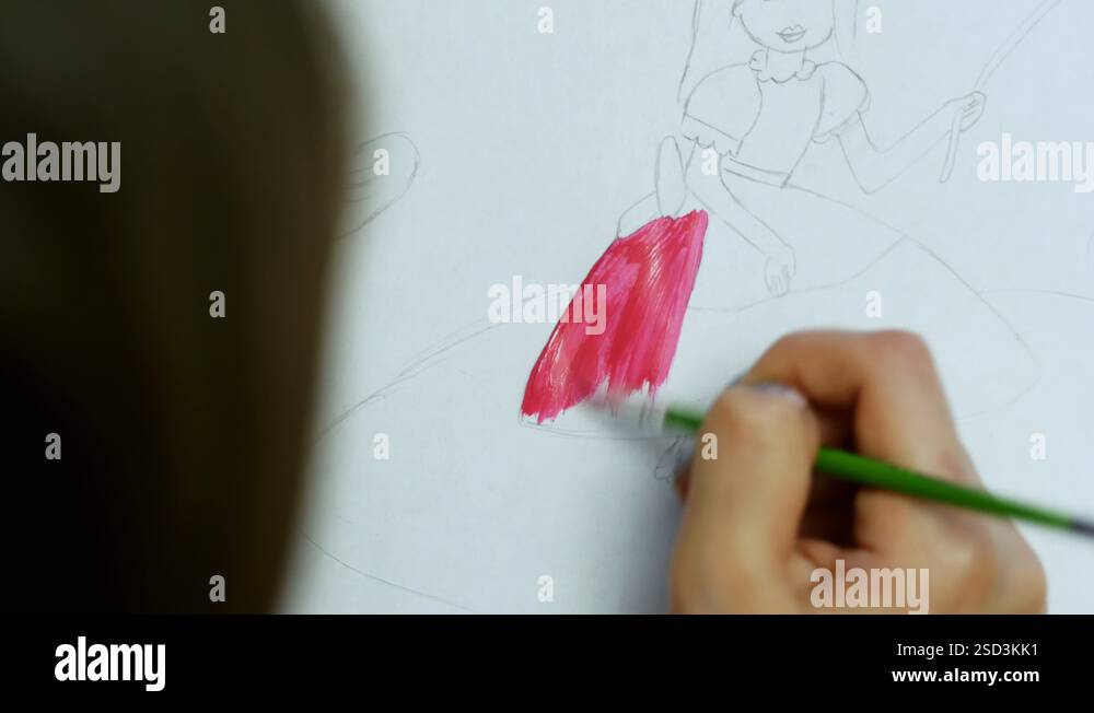 Female animator, artist draws a cartoon hero with a paint and brush ...