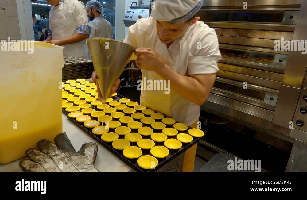 Bakery in Lisbon making the famous cream tarts called Pasteis de Nata ...