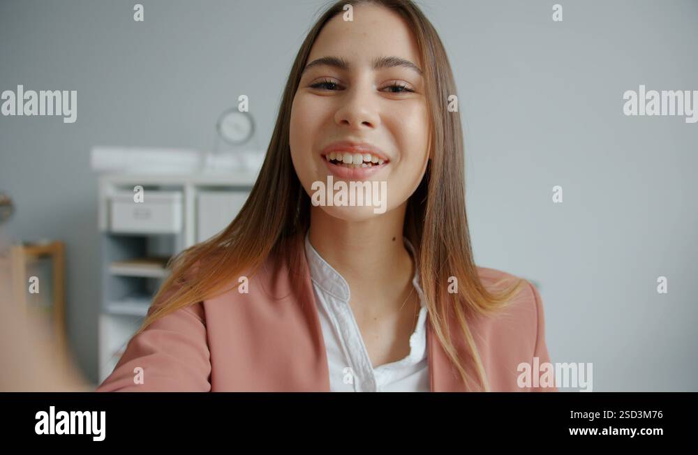 POV of cute young lady making online video call looking at camera ...