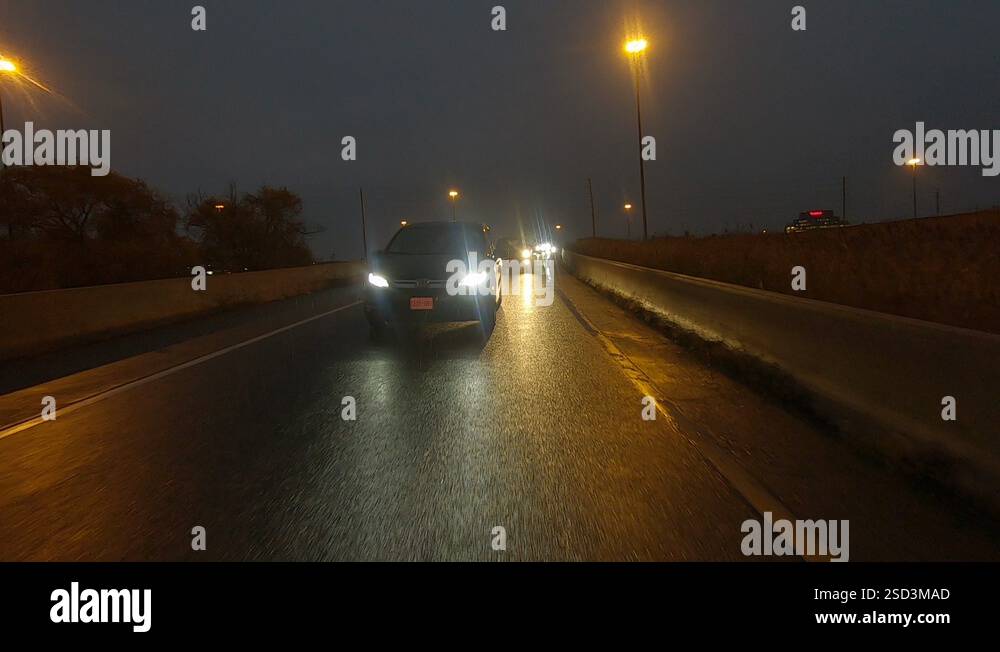 Driving Plate Rear View Pov In The Rain At Night On Streets With Car