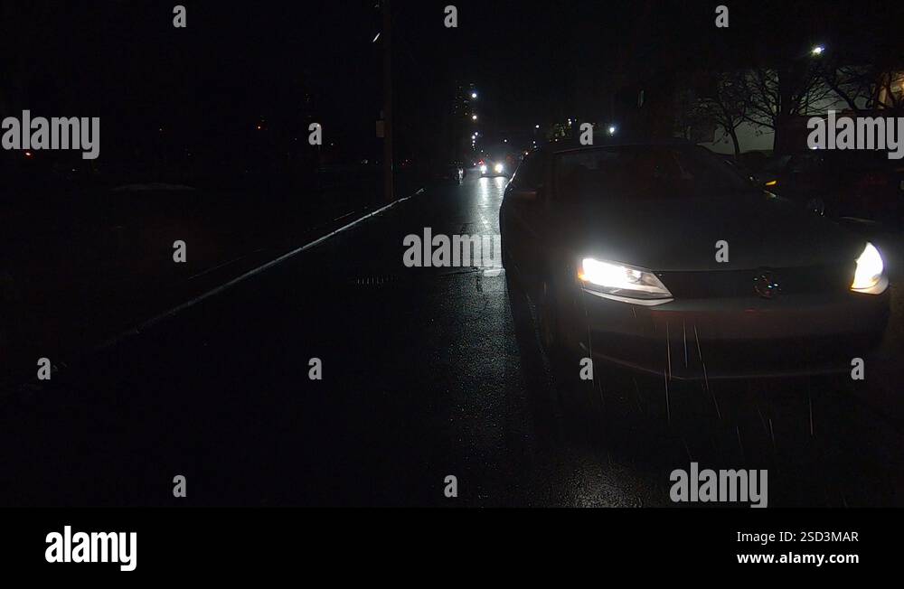 Driving plate rear view POV on a rainy at night on Toronto streets with ...
