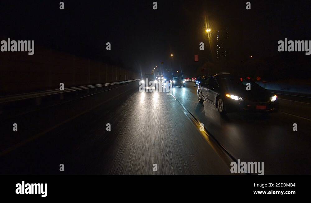 Driving plate rear view POV on a rainy at night on Toronto streets with ...