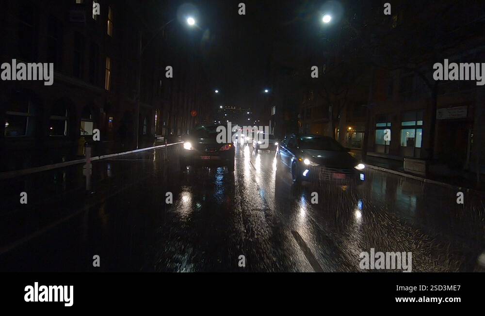 Driving plate rear view POV on a rainy at night on Toronto streets with ...
