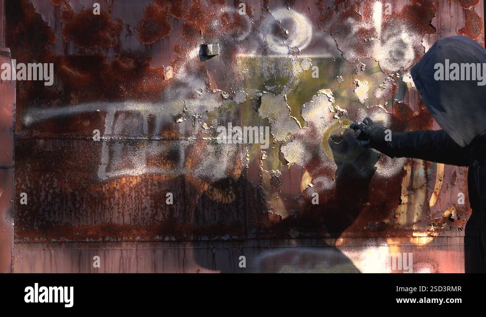 Homeless man spray painting old train wagon with aerosol can Stock ...