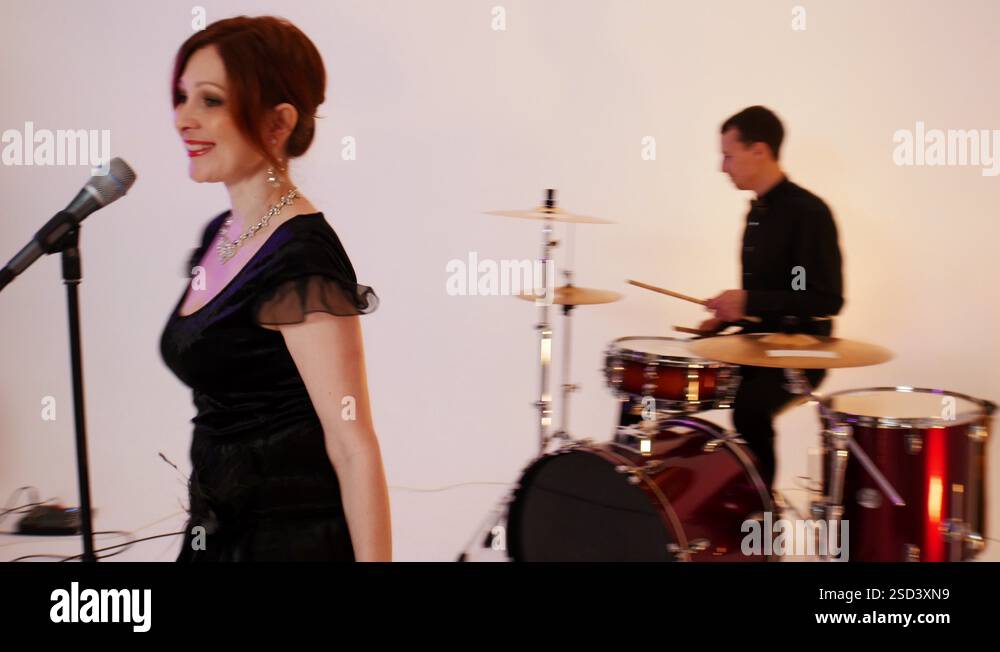 A musical band of four people in black clothes playing song in the ...