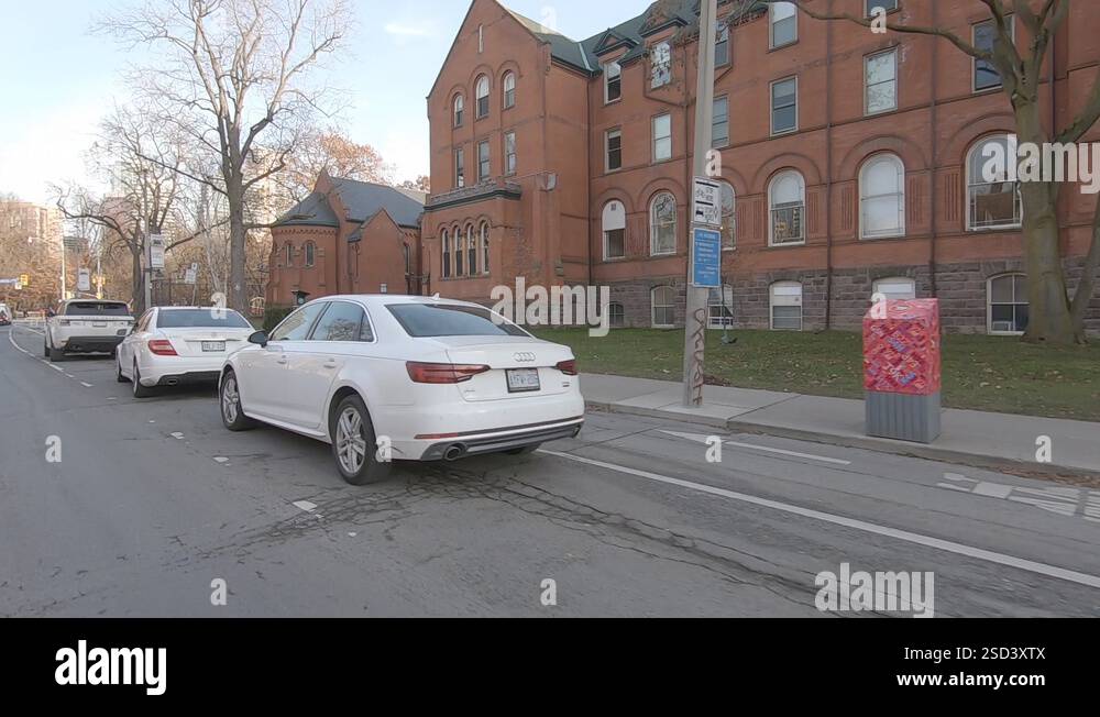 Driving plate side view POV university of Toronto campus with students ...