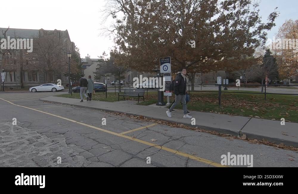 Driving plate side view POV university of Toronto campus with students ...