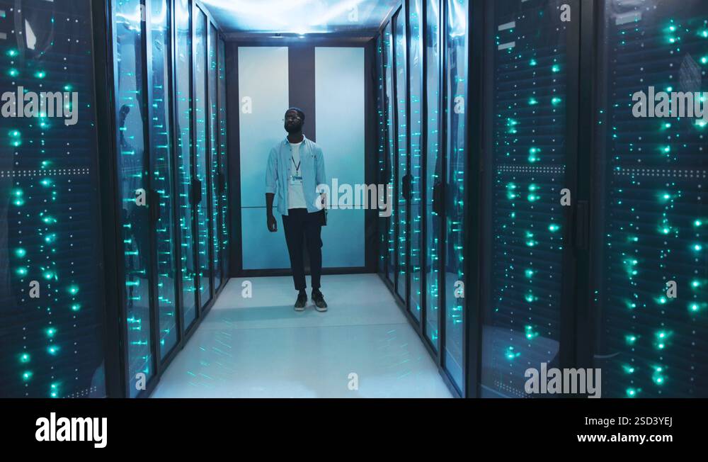 Afro-american young IT specialist working in high secure server storage ...