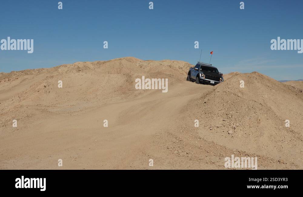 Customized Ford F-150 Raptor SVT driving off-road in a desert OHV state ...