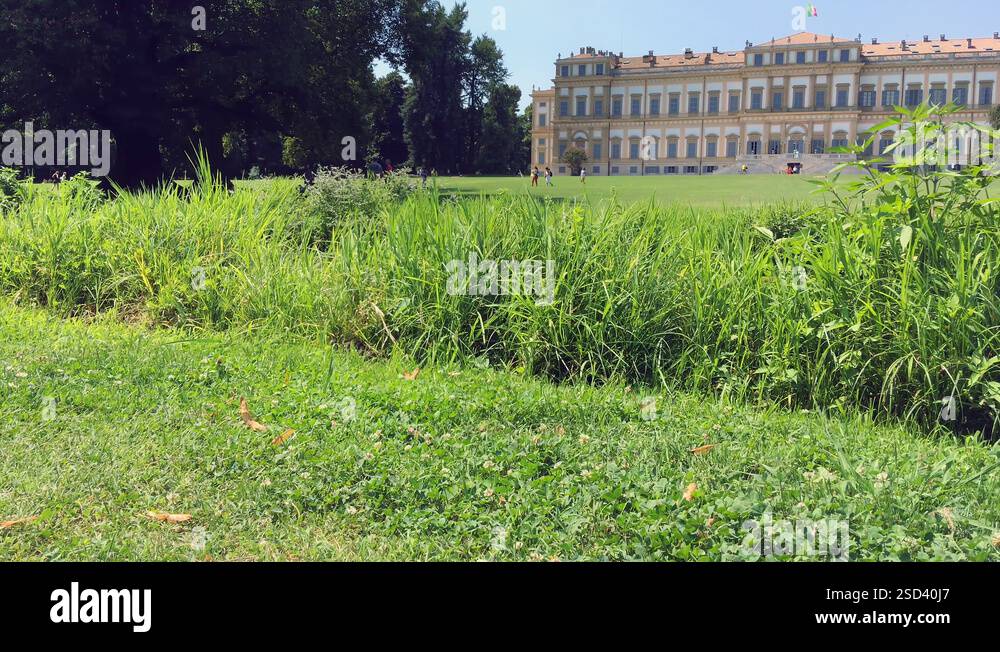 the lawn, the pond and the building of the royal palace of Monza Stock ...
