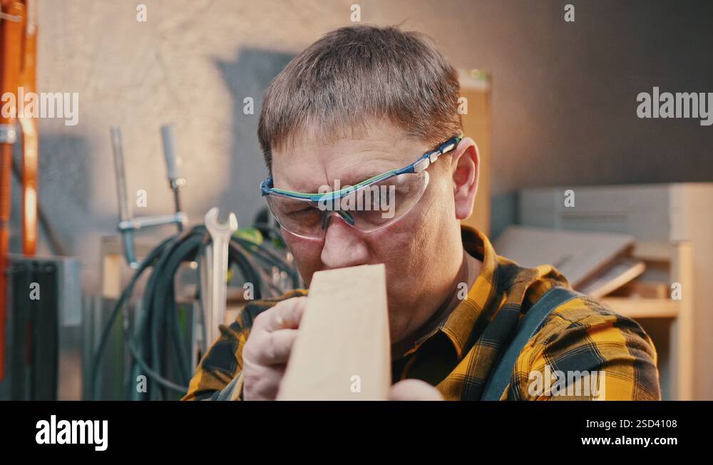 Carpentry industry - working in the workshop - a woodworker inspect ...