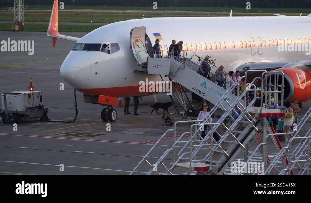 BORISPOL, UKRAINE - JUNE 2019: Passengers of a passenger airliner leave ...