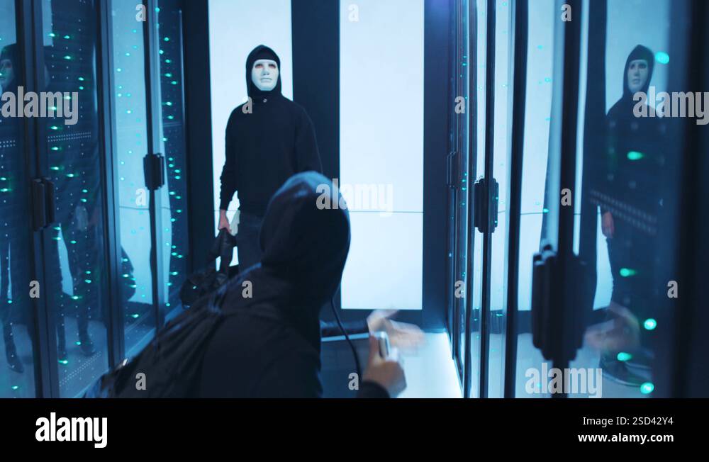 Group of cyber criminals hacking and computing data center server room ...