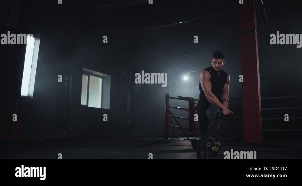 Charismatic strong fit body man practicing cross fit exercises with the ...