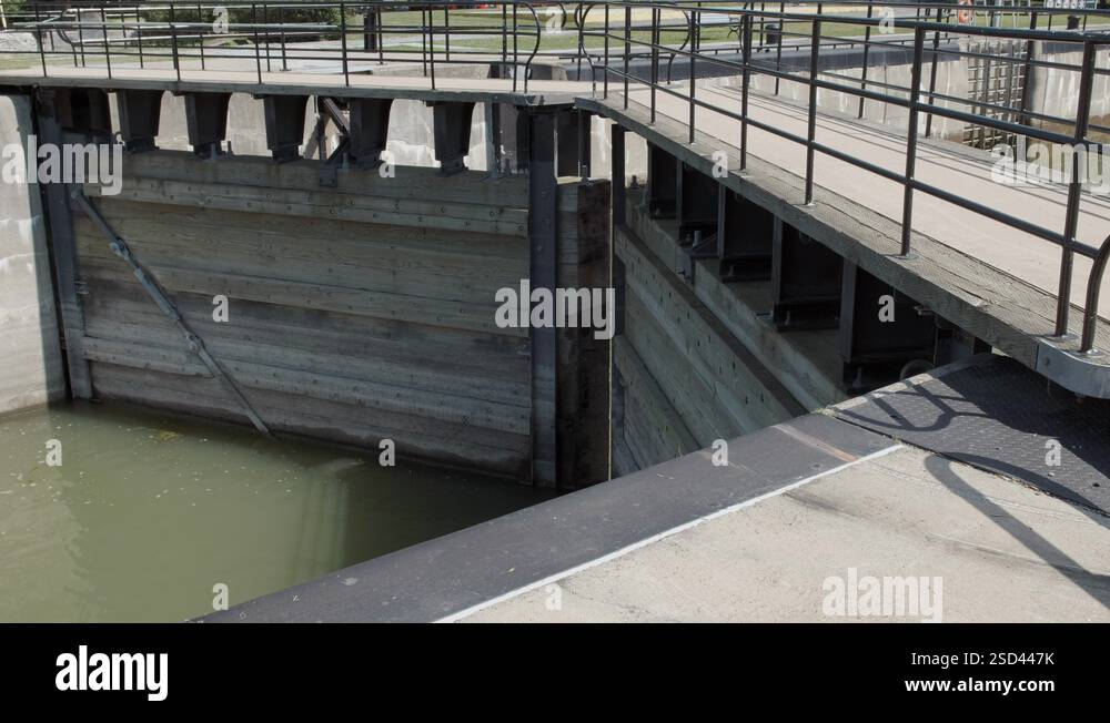 Sluice Doors Closing with Water and Footbridge. 4K Stock Video Footage ...