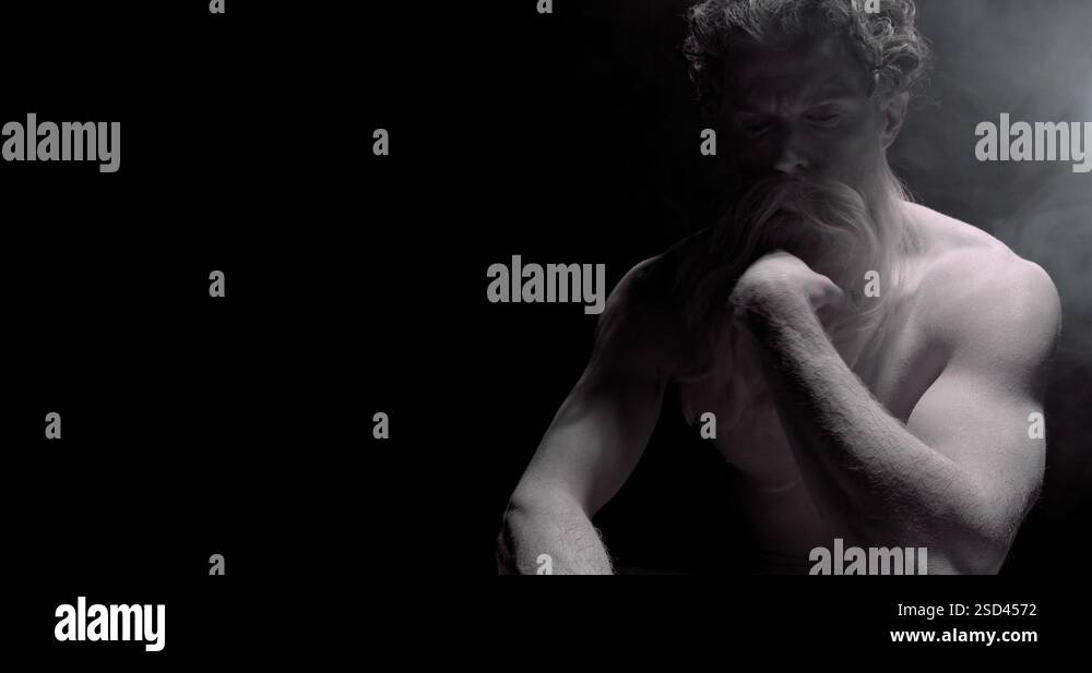 Living statue of an ancient greek God thinking and stroking his beard ...